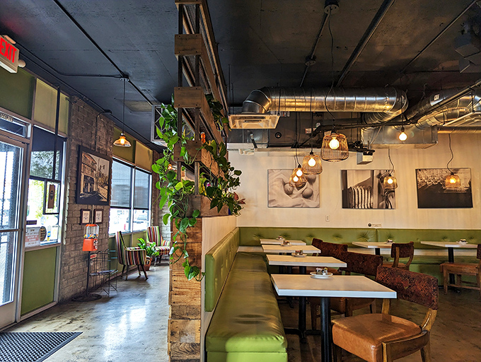 Where industrial meets inviting. Plants cascade from shelves while pendant lights cast a glow that says, "Stay awhile, the pancakes are worth it."