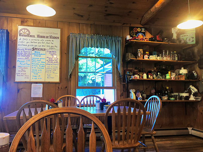 "Waterwheel Words of Wisdom" board offers specials and life advice. The blue-checkered curtains add that touch of grandma's kitchen we all secretly crave.