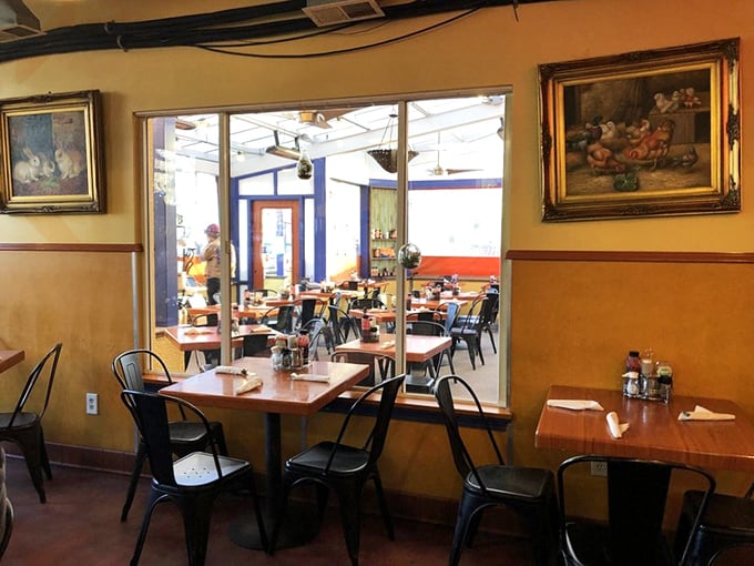 A glimpse through the window reveals the dining room where breakfast dreams come true, framed by warm walls and thoughtful design.