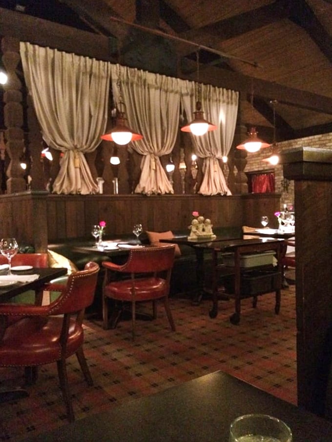 Those draped curtains and pendant lights create dining nooks that feel like you've wandered into someone's extraordinarily tasteful country home.