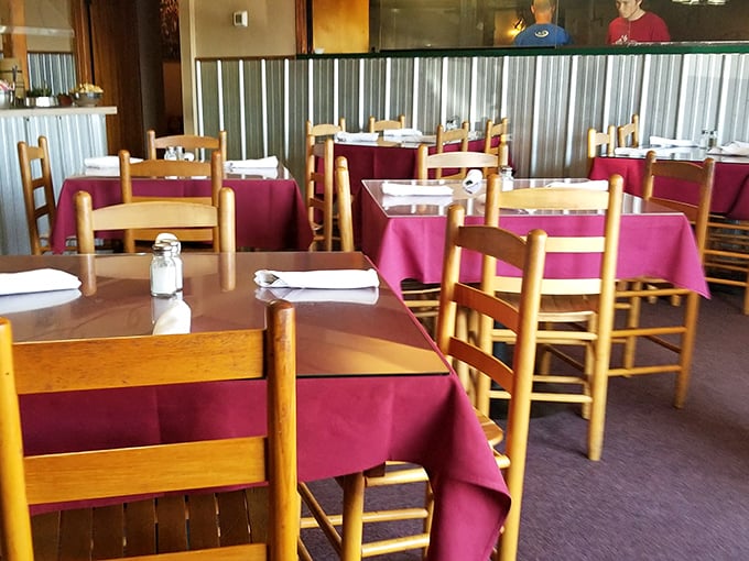 Burgundy tablecloths and wooden chairs create that "grandma's dining room meets steakhouse" vibe that makes you instantly feel at home. No pretension, just anticipation.