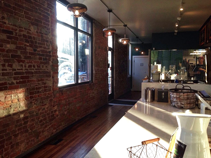 Sunlight streams through windows illuminating the brick interior—like nature itself is trying to get a better look at what's cooking.
