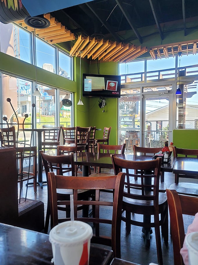 Tall windows flood the space with natural light, making the vibrant green walls pop like they've had their own shot of tequila.