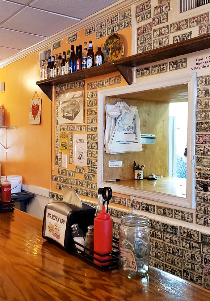 Dollar bills wallpaper the service window, each representing a satisfied customer or possibly a down payment on future cholesterol medication.