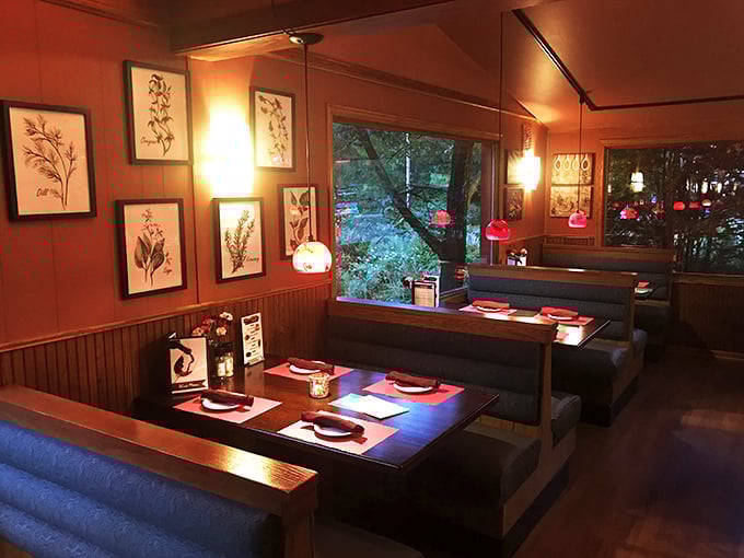 Cozy booths lined with botanical prints create intimate dining spaces where conversations flow as easily as the cocktails.