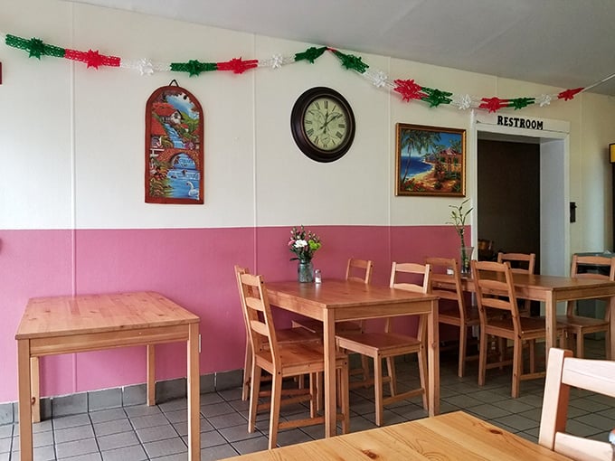Pink and white walls adorned with festive decorations create a cheerful backdrop for serious eating. Simplicity with a splash of color.