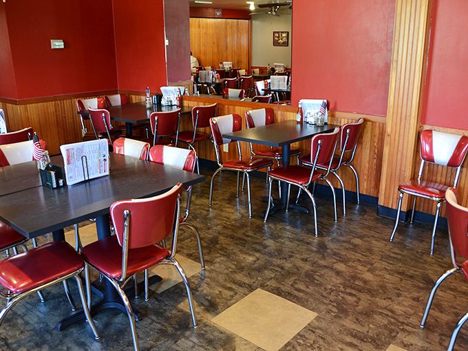 The dining room's warm wood paneling and red walls create a cozy atmosphere that says, "Stay awhile, there's pie coming."