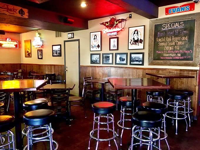 Classic bar stools, wood paneling, and neon signs create the perfect backdrop for serious burger business.