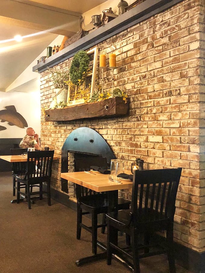 That exposed brick fireplace anchors the dining room like a reliable old friend. Rustic elegance without trying too hard.