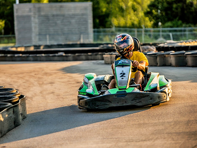 Leaning into the turn with laser focus, this driver demonstrates why go-karting is secretly the most intense therapy session you can have with an engine.
