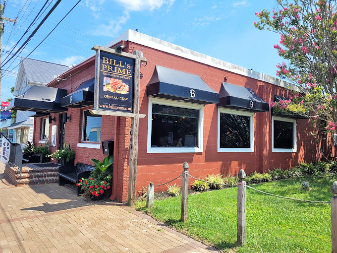 Bill's brick exterior stands like a culinary lighthouse, guiding hungry travelers to safe harbor. The flowers are just showing off.