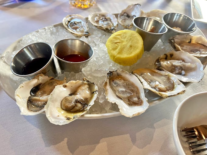 The restaurant's signature blue glassware adds a pop of oceanic color to tables dressed in crisp white linens&mdash;a visual appetizer.