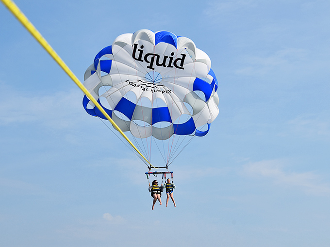 Nothing says "I'm living my best vacation life" quite like dangling from a parachute 800 feet above the Atlantic, questioning every life decision.