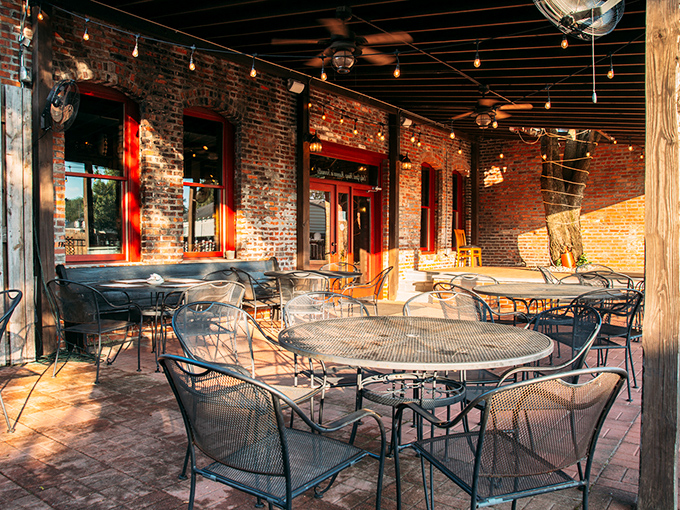The brick patio invites relaxed dining under string lights, where summer evenings stretch long and conversations flow easily.