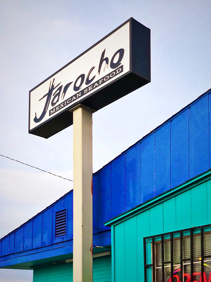 The sign stands tall against the Kansas sky, a beacon for seafood lovers who know that great cuisine can thrive anywhere.