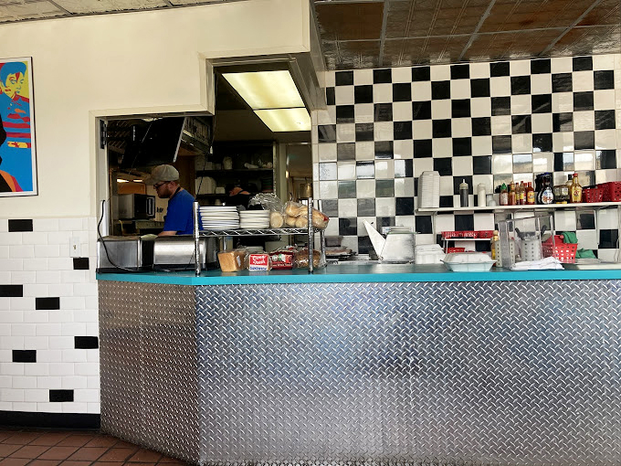 Behind this pass-through window, short-order wizards transform simple ingredients into the comfort food of your childhood memories.