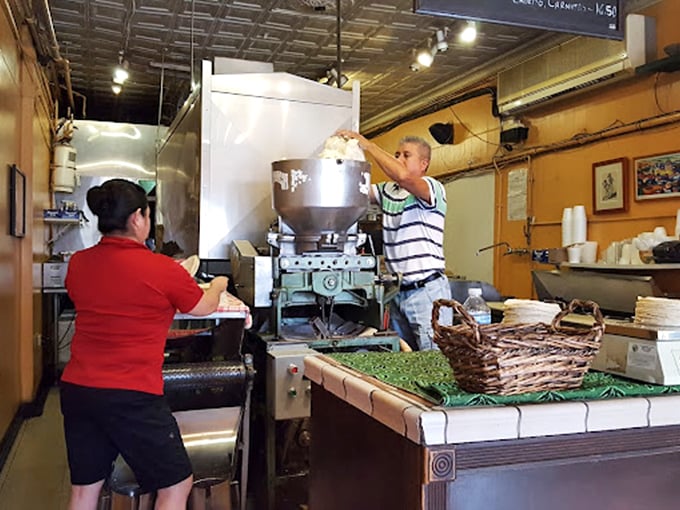 Culinary choreography in action as fresh masa transforms into perfect tortillas. This is the kind of behind-the-scenes craftsmanship that makes every bite extraordinary.