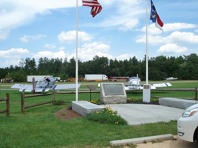 American flags stand proud near vintage aircraft, reminding you this isn't just dinner&mdash;it's a uniquely North Carolina experience with wings.
