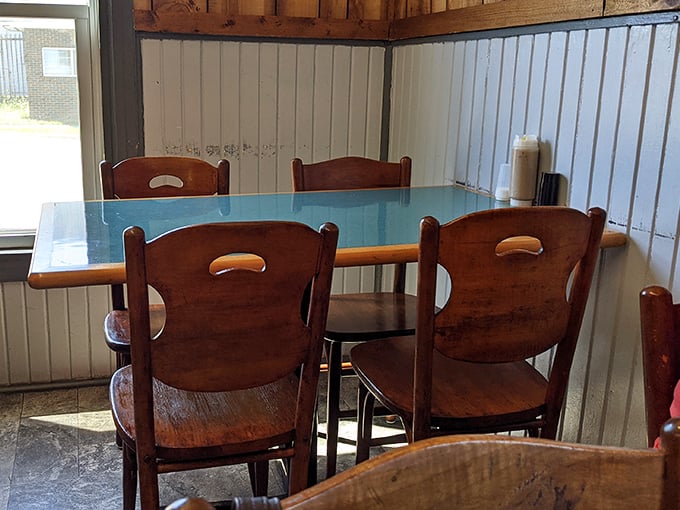 The blue-topped tables offer front-row seats to the comfort food show, where every chair has hosted countless satisfied diners.