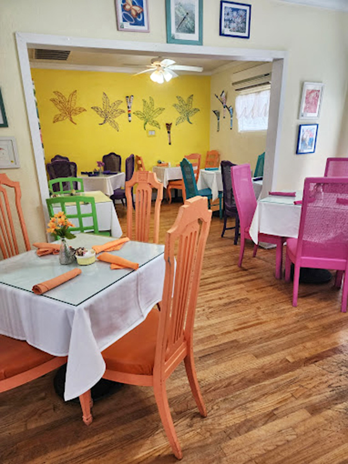 The dining room's color palette would make Frida Kahlo nod in approval—coral chairs, yellow walls, and white tablecloths creating a cheerful morning symphony.