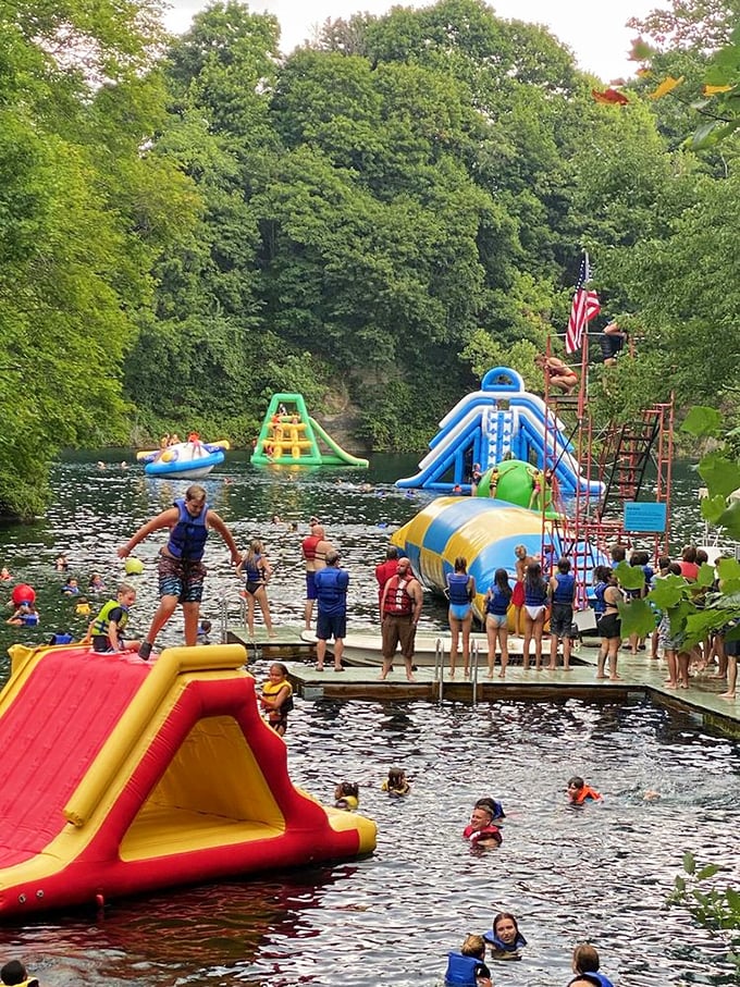 Summer joy personified! Kids and adults alike line up for their chance to conquer the floating playground, while lifeguards ensure enthusiasm doesn't outpace safety.