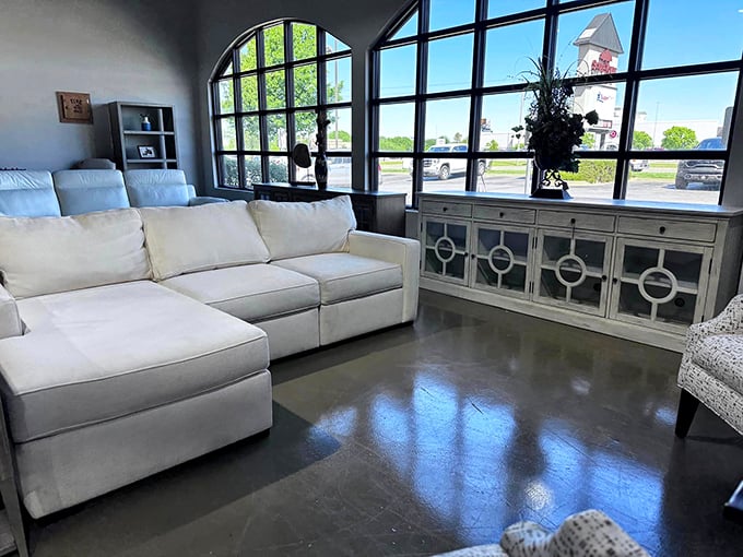 Sunlight streams through architectural windows, illuminating a sectional so pristine you'd swear it teleported directly from a furniture showroom.