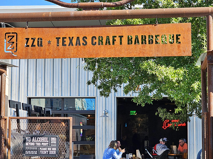 ZZQ's industrial-cool sign announces Texas craft barbecue without apology. That rusty metal isn't worn &ndash; it's seasoned, just like their perfect brisket.