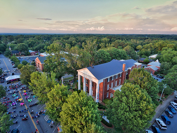 Main Street stretches toward possibility, brick buildings and blue skies creating the quintessential small-town Georgia postcard.