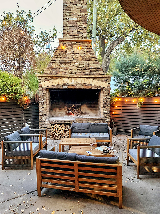 The outdoor fireplace at Urban Grub creates a gathering spot where seafood stories are shared and Nashville nights become magical memories.