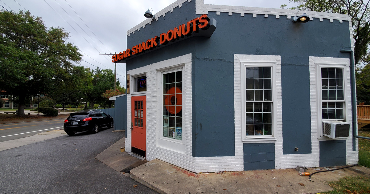 The blue-gray exterior with that coral door isn't just inviting&mdash;it's practically a siren song for your sweet tooth. Richmond's donut paradise awaits. 
