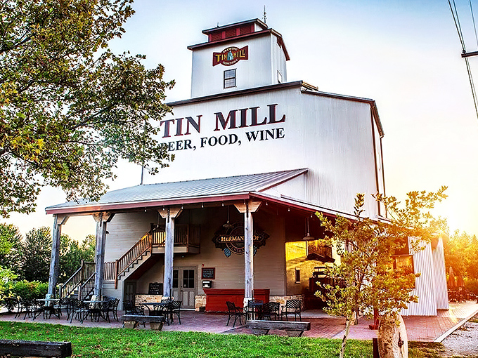 The iconic white exterior of Tin Mill Restaurant stands tall against the Missouri sky, promising German-American delights inside this converted historic building.