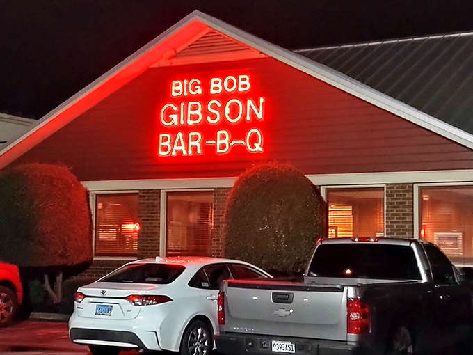The neon sign glows like a barbecue beacon, promising smoky salvation to hungry travelers. Big Bob Gibson's exterior says it all: serious barbecue happens here.