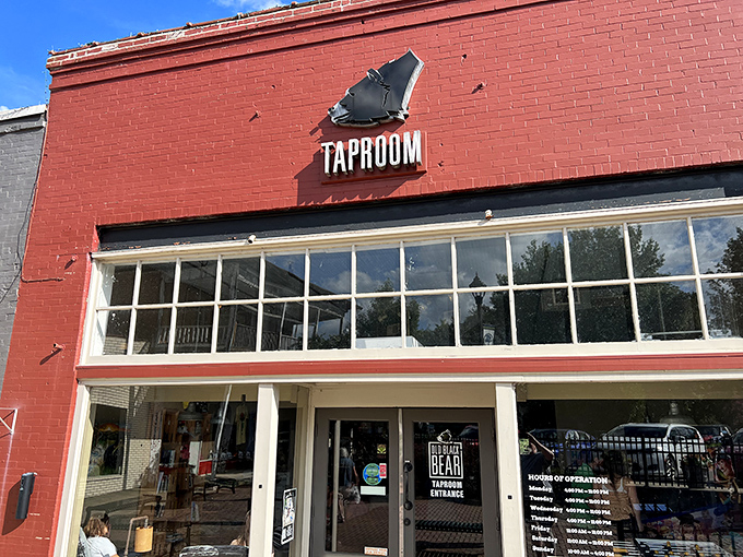 The bright red brick exterior of Old Black Bear's taproom stands as a beacon of culinary promise in historic downtown Madison.