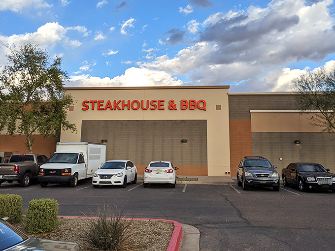 The unassuming exterior of Hideout Steakhouse & BBQ proves once again that culinary treasures often hide in plain sight. Desert dining at its finest awaits inside.