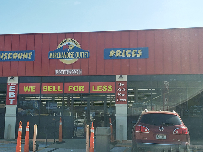 The bright red exterior of Main Street Merchandise Outlet practically shouts "bargains inside!" like a carnival barker with actual deals to offer.