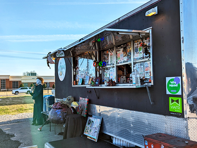 This isn't your average food truck &ndash; it's a haunted mansion on wheels, beckoning hungry souls with its matte black exterior and pink neon logo.
