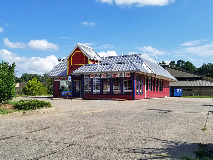The bright red exterior of Sam's Southern Eatery stands out like a culinary lighthouse, beckoning hungry travelers with promises of comfort food treasures within.