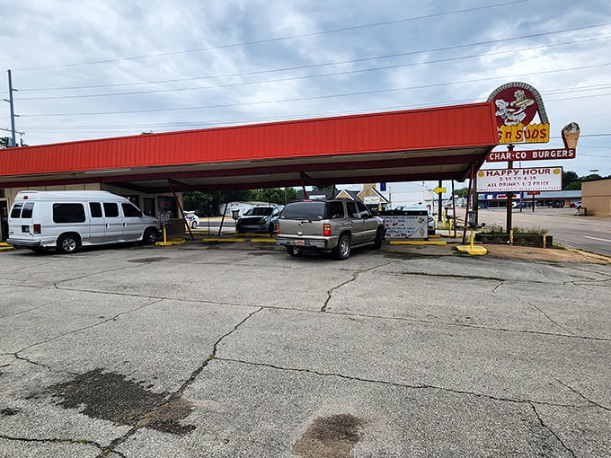The iconic red-roofed Dog N Suds stands like a time capsule against the Arkansas sky, beckoning hungry travelers with promises of nostalgic delights.