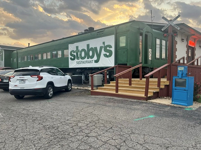 The iconic green train car of Stoby's stands proudly against an Arkansas sunset, promising culinary adventures that don't require a ticket.
