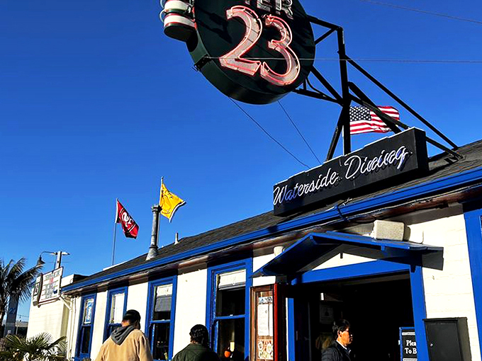 The iconic "23" sign beckons like a lighthouse for hungry souls navigating San Francisco's Embarcadero. Blue trim, waterfront charm, and promises of seafood paradise await.