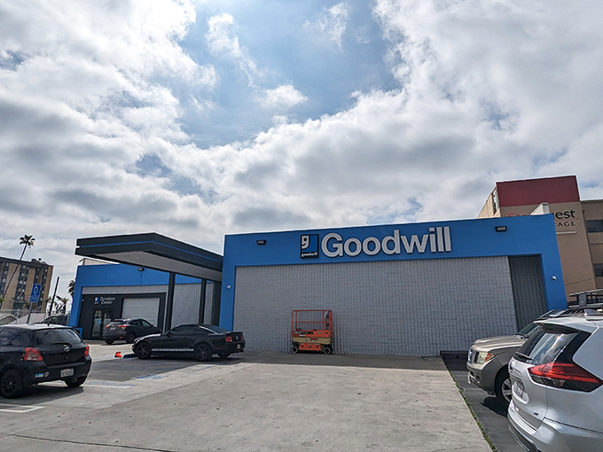 The iconic blue facade of Goodwill on Sunset Boulevard stands like a beacon for treasure hunters. Hollywood's best-kept secret hides in plain sight.