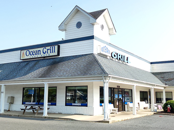 The white clapboard exterior of Ocean Grill stands like a beacon of comfort food promise. Those nautical round windows aren't just for show&mdash;they're portals to flavor town.