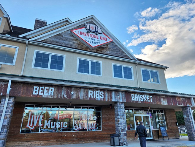 The rustic wooden fa&ccedil;ade of Limestone BBQ and Bourbon promises what every barbecue pilgrim seeks: a temple where smoke, meat, and time create magic.