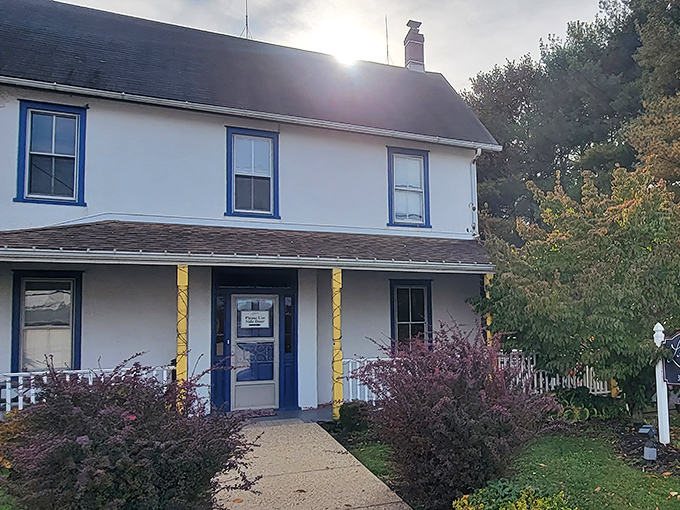 The unassuming white farmhouse exterior of Lettie's Kitchen stands like a culinary time capsule, complete with the guardian rooster statue announcing "serious chicken business happens here."