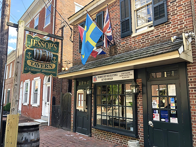 History flies proudly outside Jessop's Tavern, where international flags flutter above brick-lined streets that have witnessed centuries of American stories.