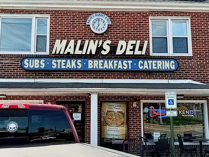 The unassuming brick facade of Malin's Deli stands like a sandwich sentinel in Newark, promising delicious treasures within for those wise enough to stop.