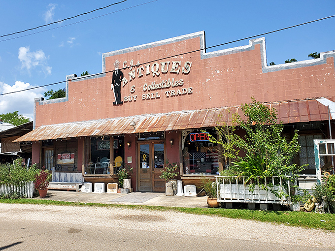 The vibrant red facade of C.J.'s Antiques & Collectibles stands out like a beacon for treasure hunters, promising adventures in nostalgia beneath that rustic metal roof.