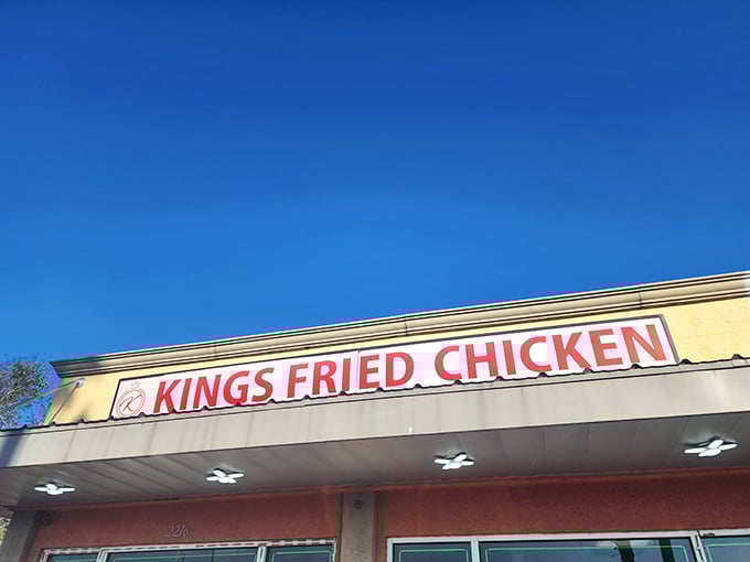 The bright yellow facade with bold red lettering stands as a no-nonsense declaration: this place means serious business when it comes to fried chicken.