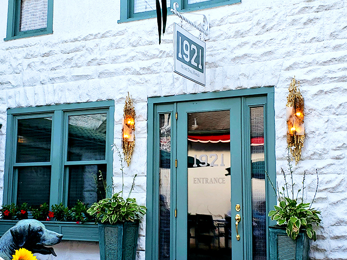 A welcoming white archway leads to culinary paradise, where even the dog statue seems to be saying, "Trust me, you're going to love this place."