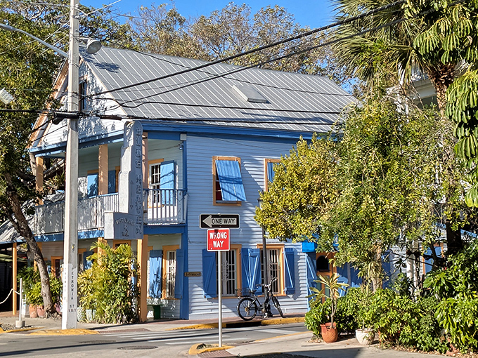 The iconic blue fence and hand-painted sign welcome you to Blue Heaven, where Key West's quirky spirit meets culinary paradise.